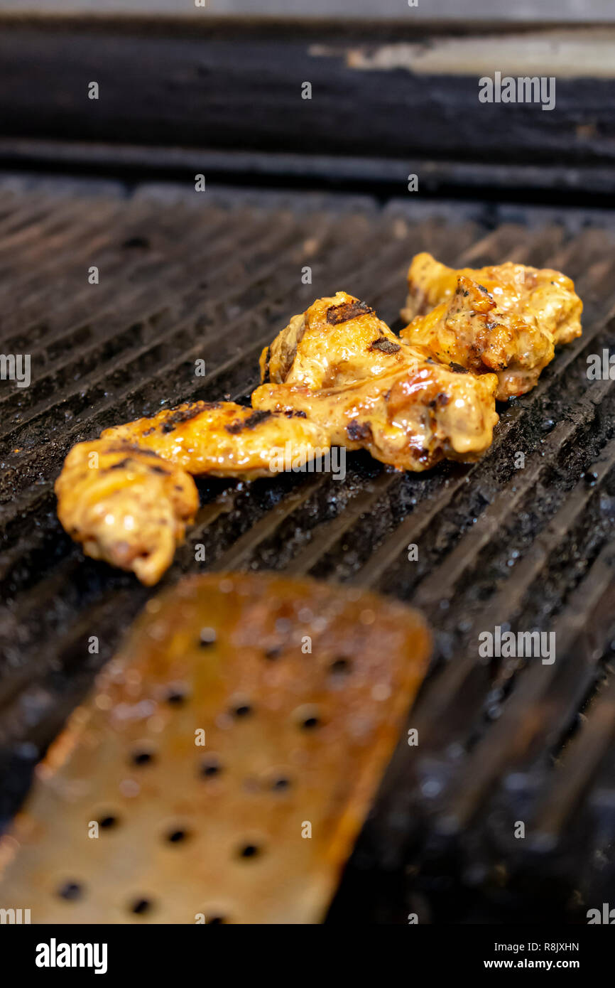 Glazed chicken wings on a restaurant grill with char marks Stock Photo ...