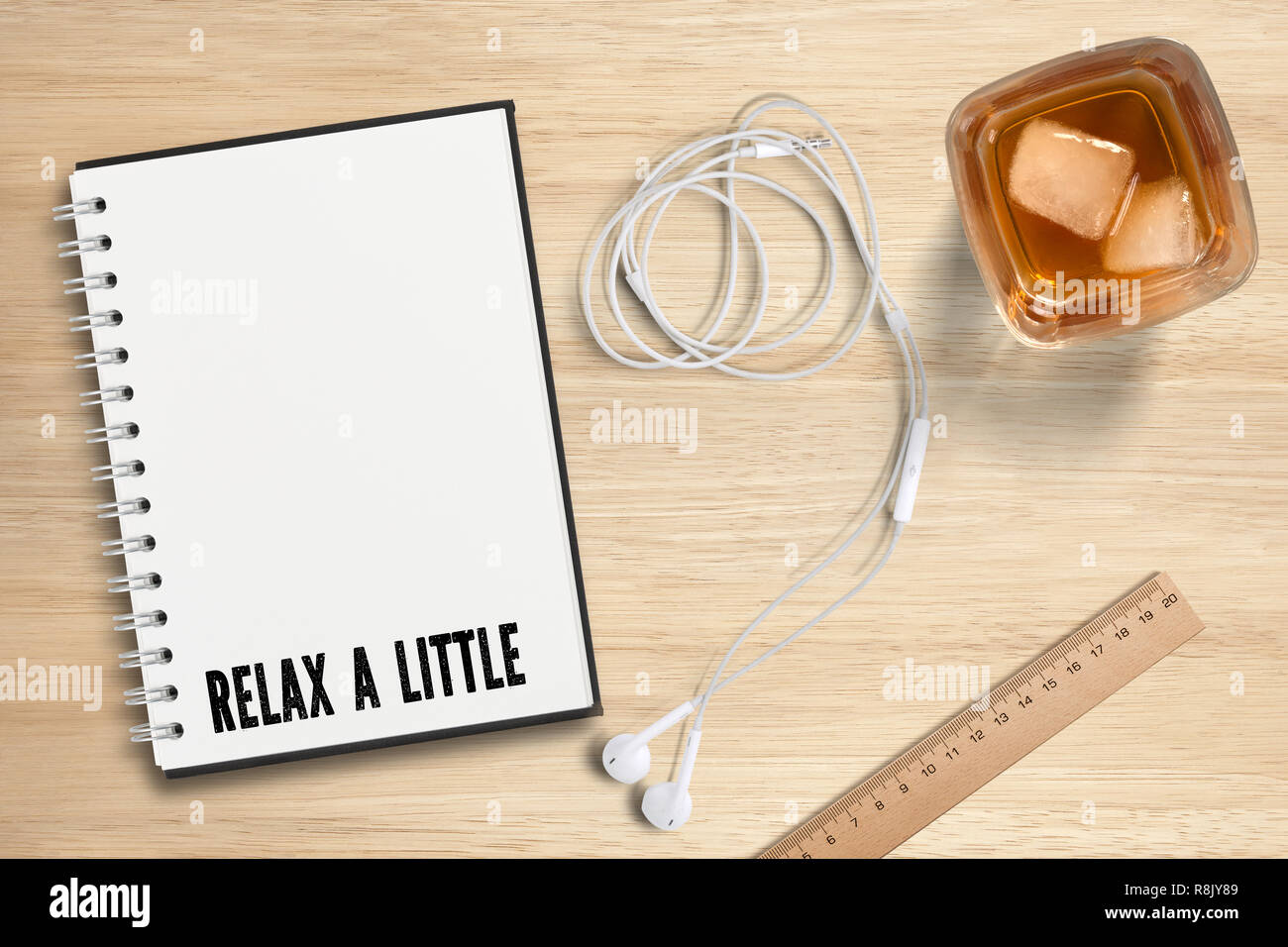 Notepad with message "Relax a little" at a workplace on wooden ...