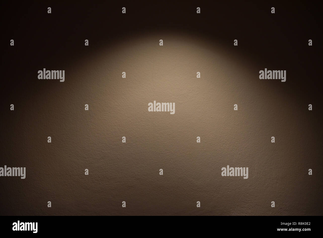 light on wall - the lamp shines with warm light on brown wall / light ...