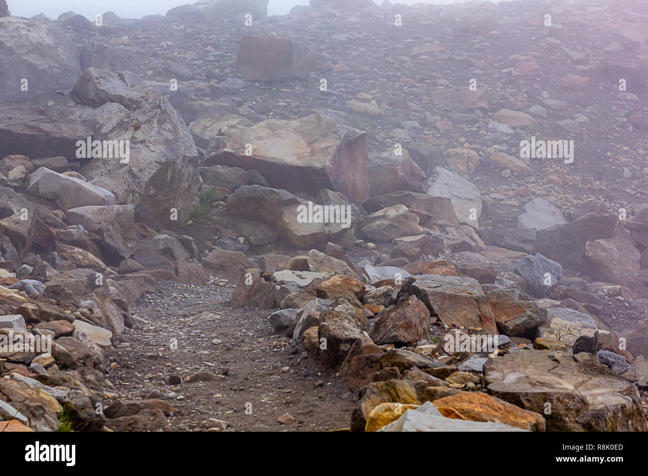 harsh stone and graval pathway for hiking in fog and clouds Stock Photo ...