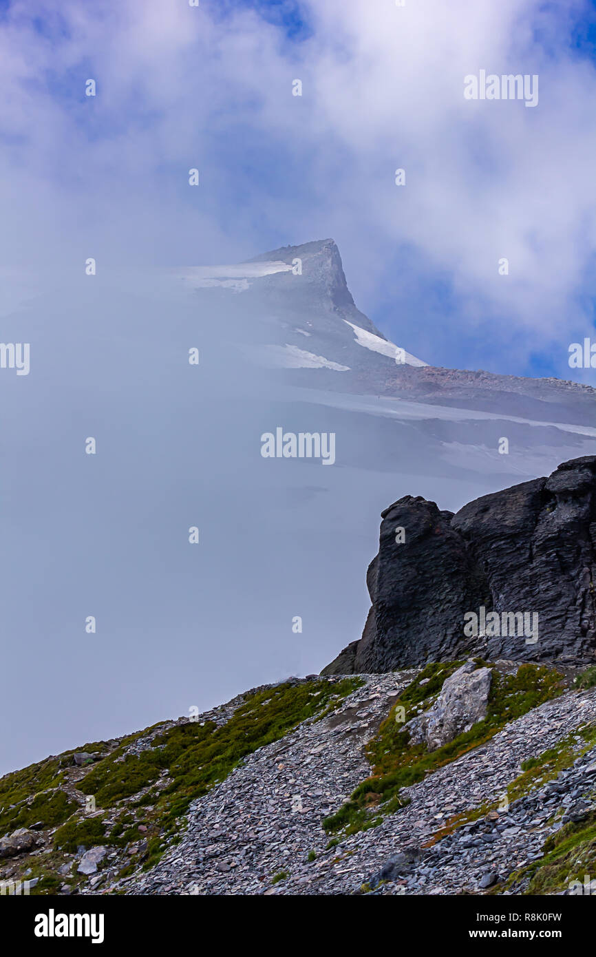 harsh stoney mountain with cold cloud and fog cover 2 Stock Photo - Alamy