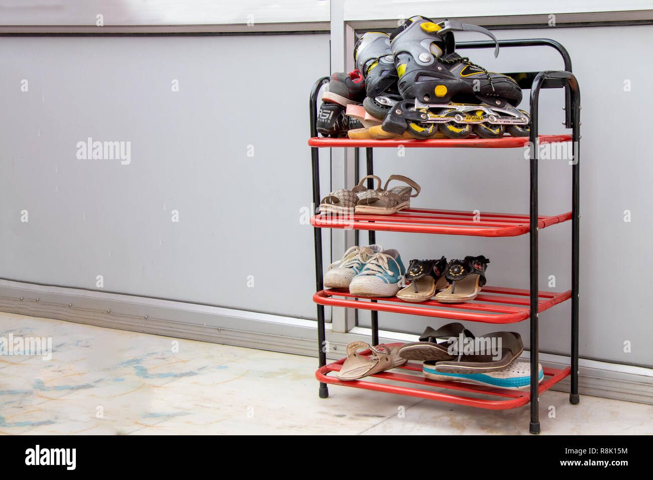 Red and black color shoes stand, shoes placed on stand in house Stock ...