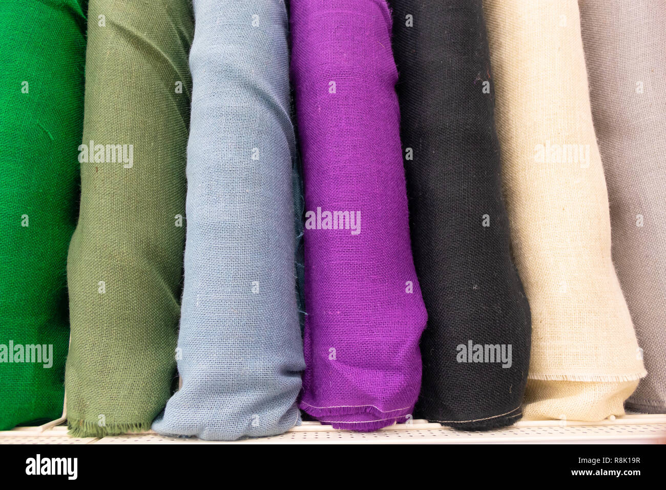 bundles of colorful cloth on display in shop Stock Photo - Alamy