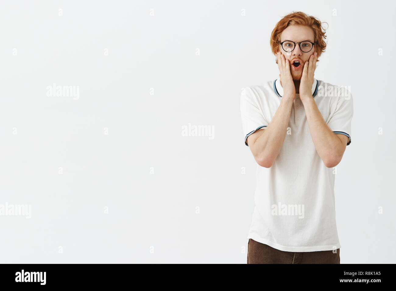 Handsome redhead male computer geek with beard in glasses and casual ...