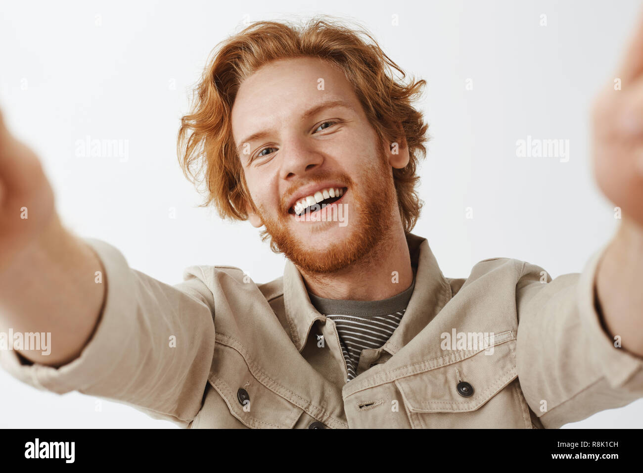 Close-up shot of charming friendly and carefree happy redhead guy with ...