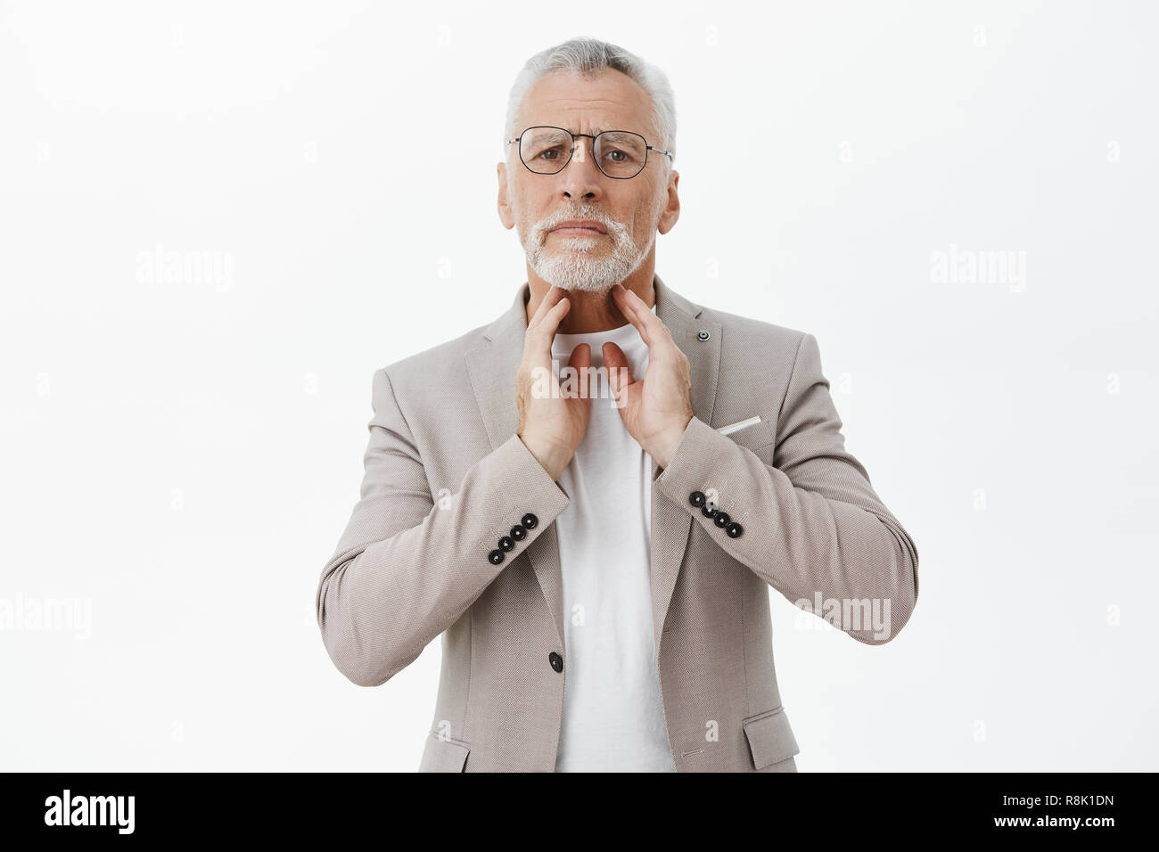 Old man feeling discomfort in throat standing gloomy and unhappy being ...