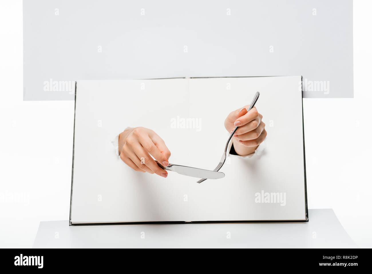 Girl holding up knife fork hi-res stock photography and images - Alamy