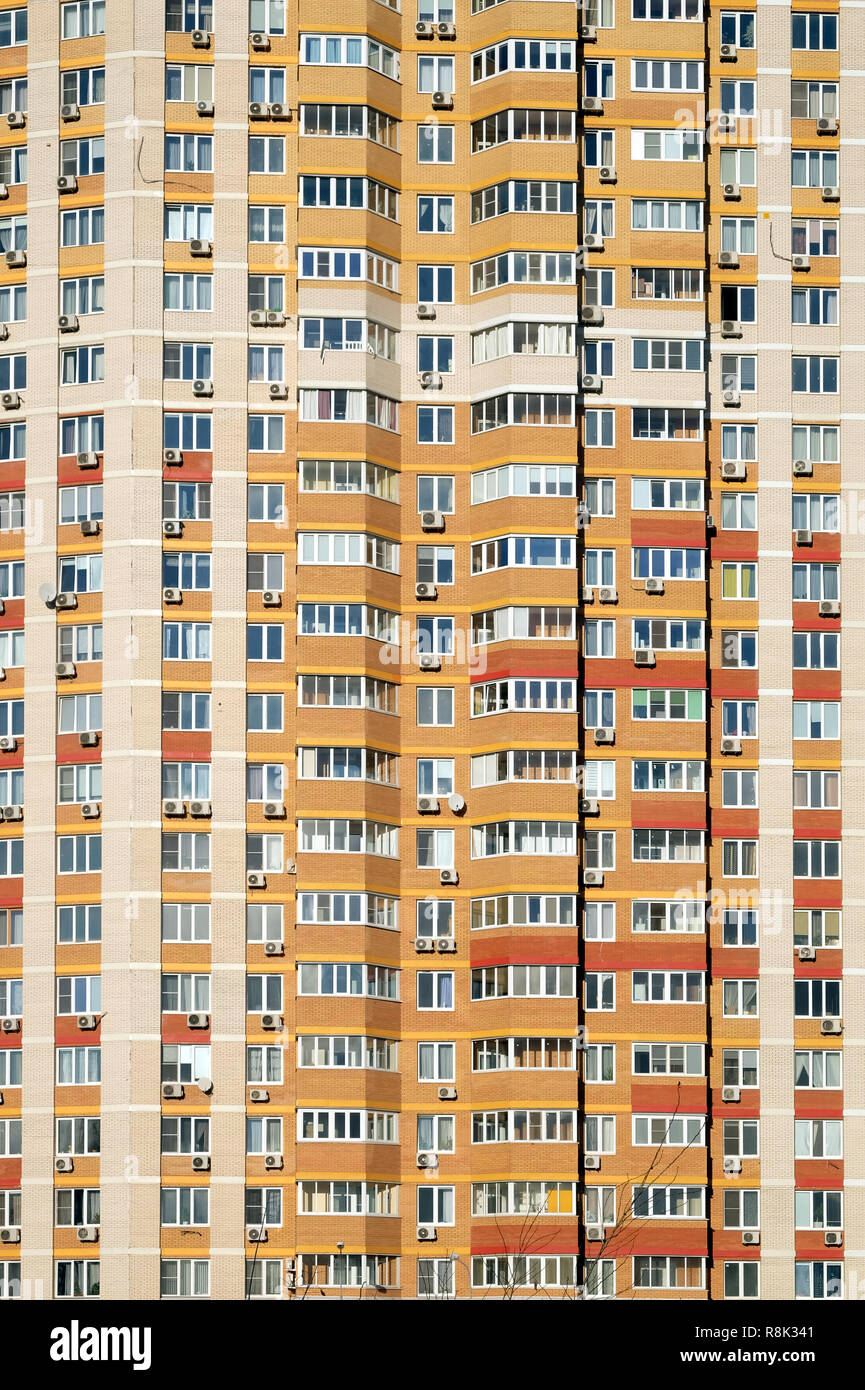 Vertical facade of a large multi-storey block of flats with many ...