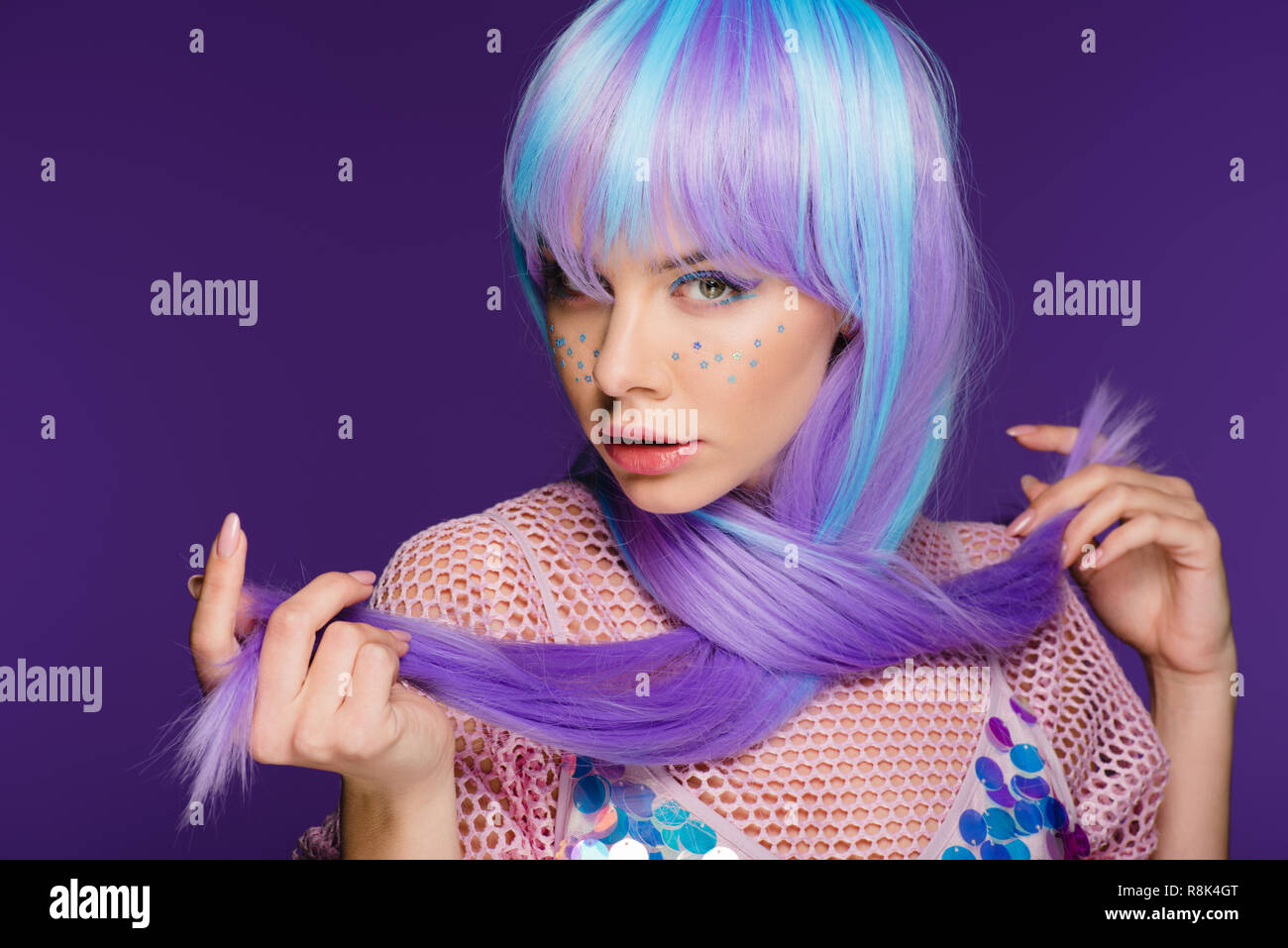 stylish attractive model posing in violet wig with stars on face ...