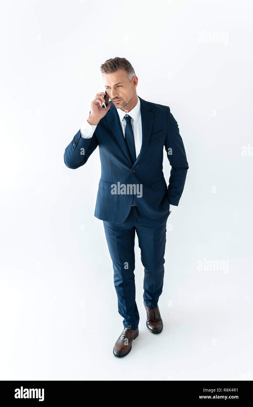 high angle view of handsome businessman talking by smartphone isolated ...