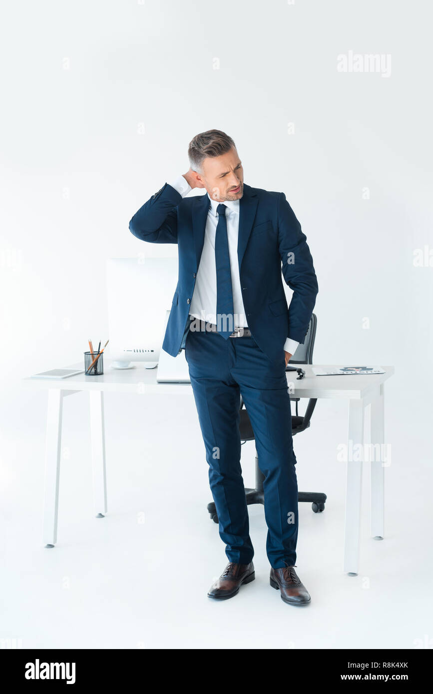 handsome businessman touching back of head isolated on white Stock ...