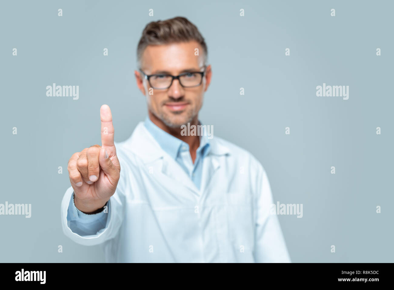 selective focus of handsome scientist touching something in air ...