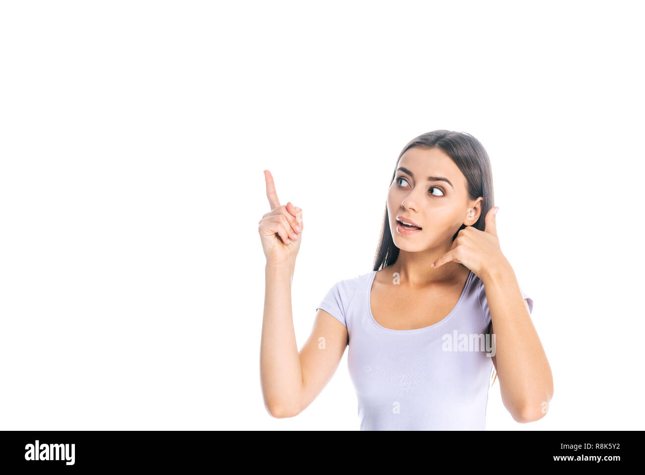 portrait of woman showing call sign and pointing away isolated on white ...