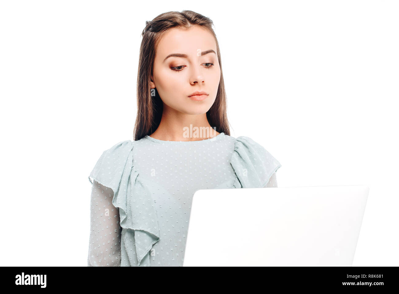 portrait of young focused woman with laptop isolated on white Stock ...