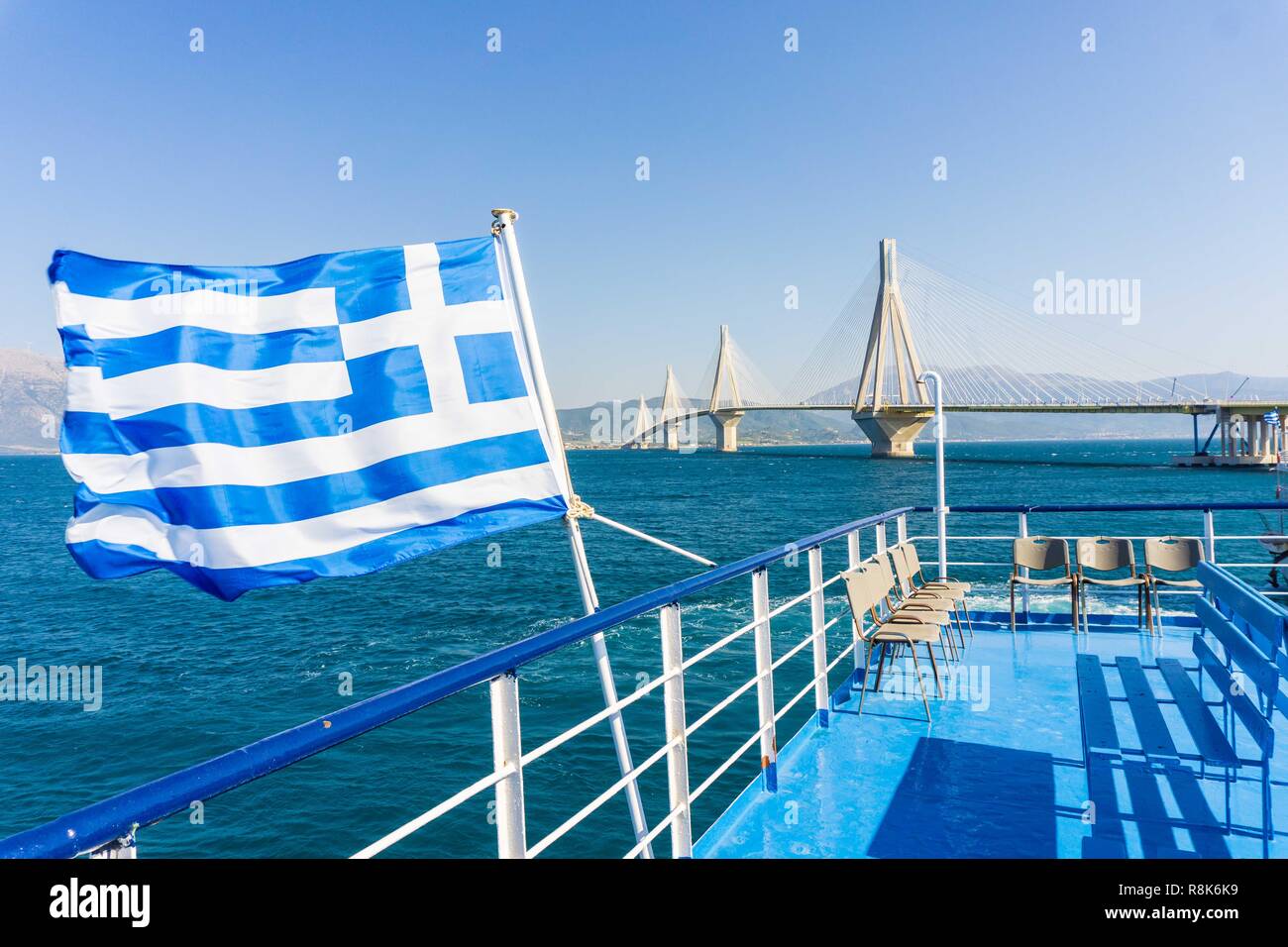 Traveling by ferry boat of Rio at Patra, Greece. A greek flag is waving ...