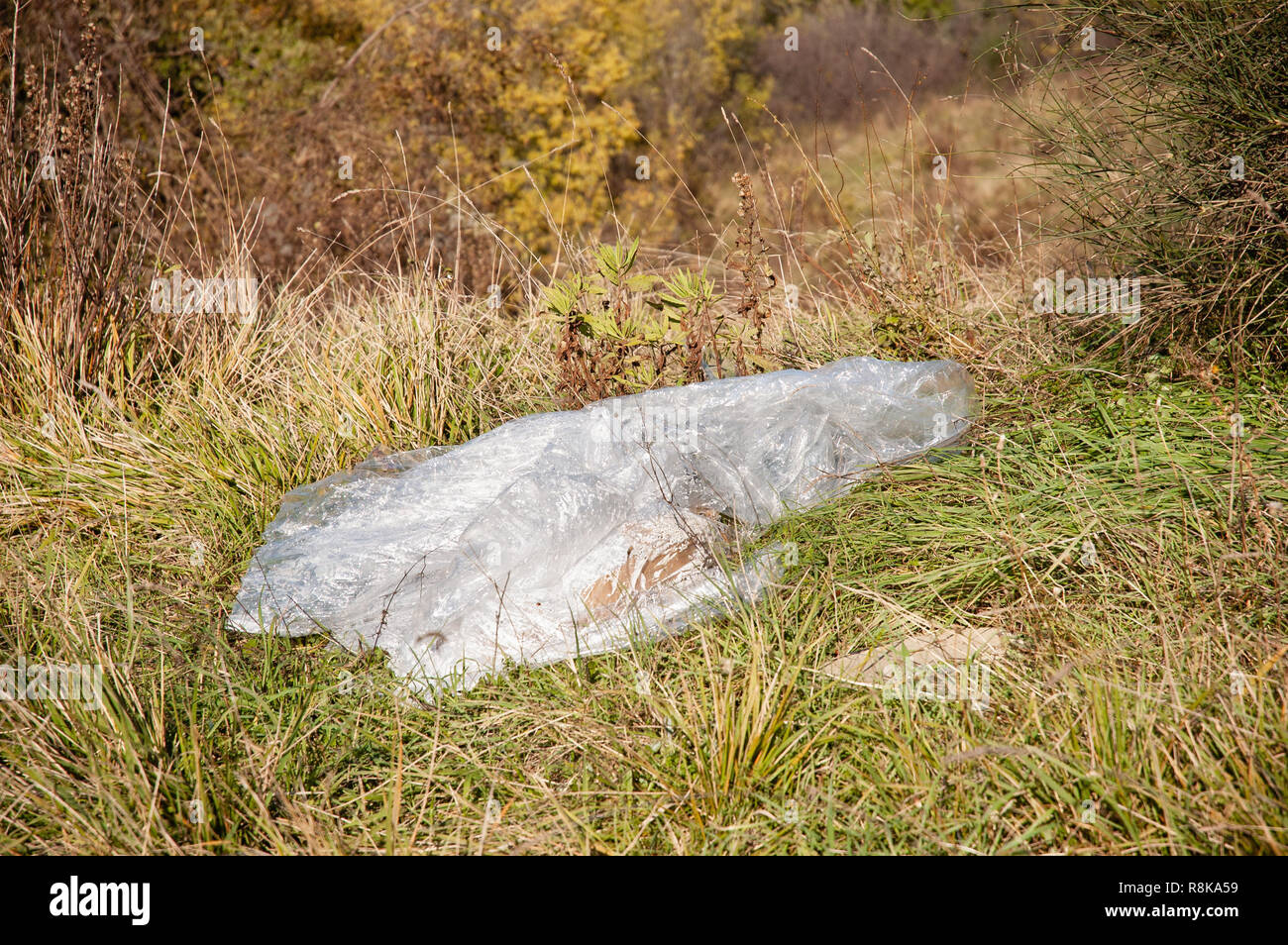 Large plastic sheet abandoned in the fields in the middle of the nature ...