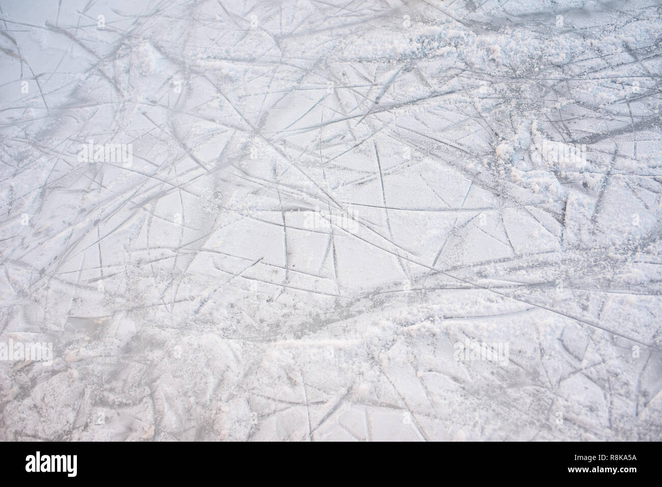 Floor background of a frozen ice rink with skate marks, with white snow ...