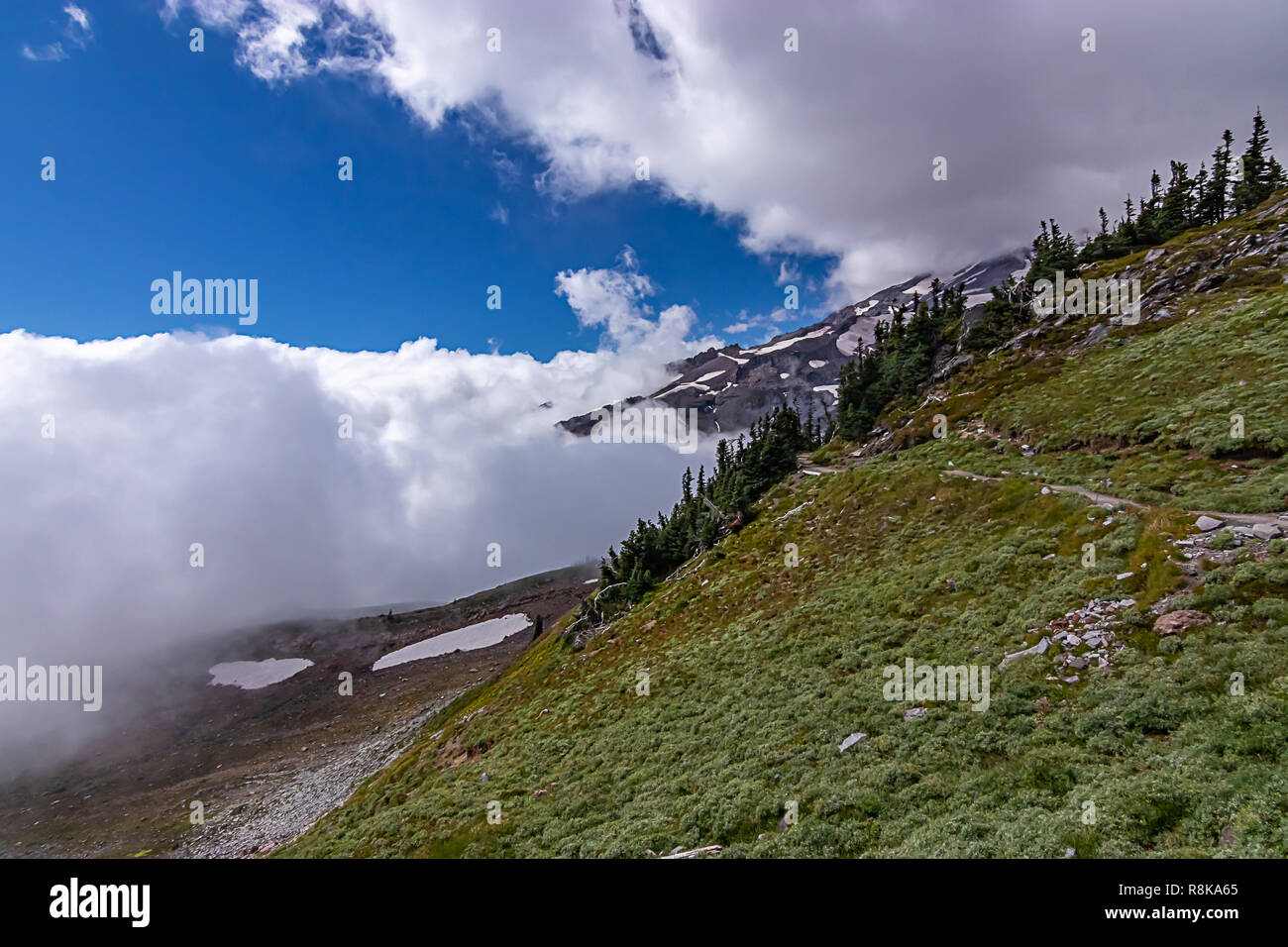 slanting mountainside and bright thick clouds Stock Photo - Alamy