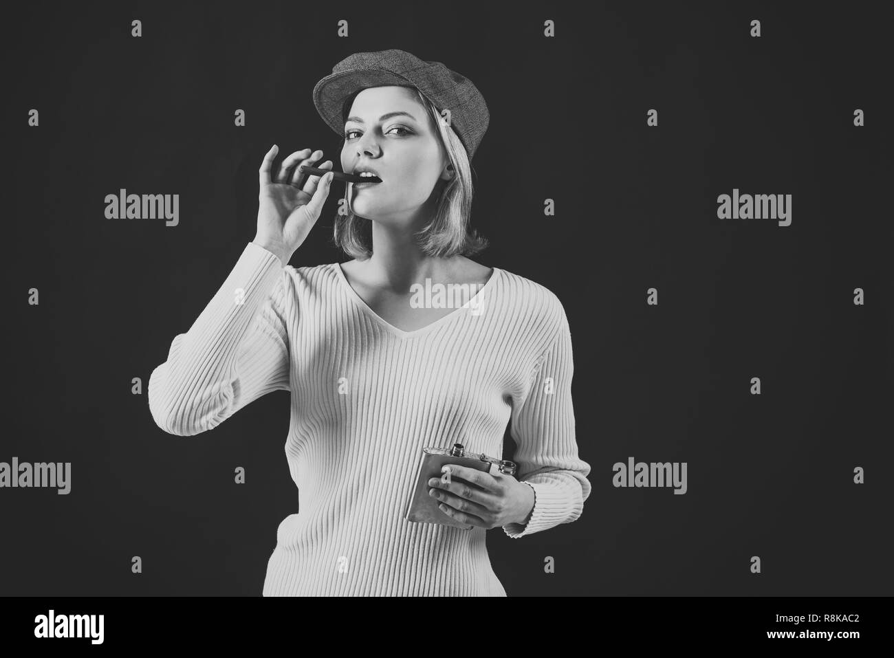 Woman on mysterious face wears kepi, dark background. Blonde lady looks ...