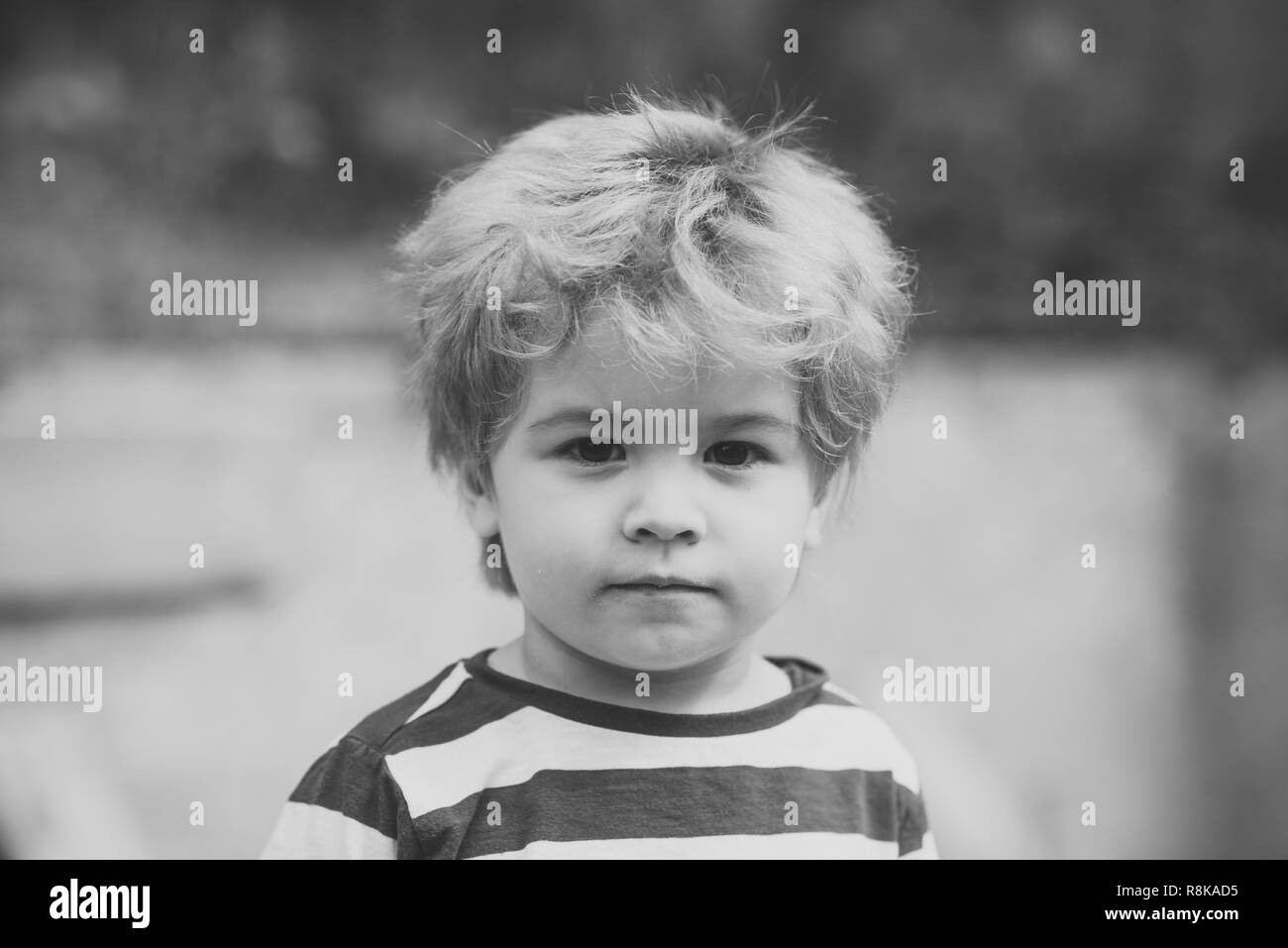 Child or boy with serious face wears striped clothes Stock Photo - Alamy