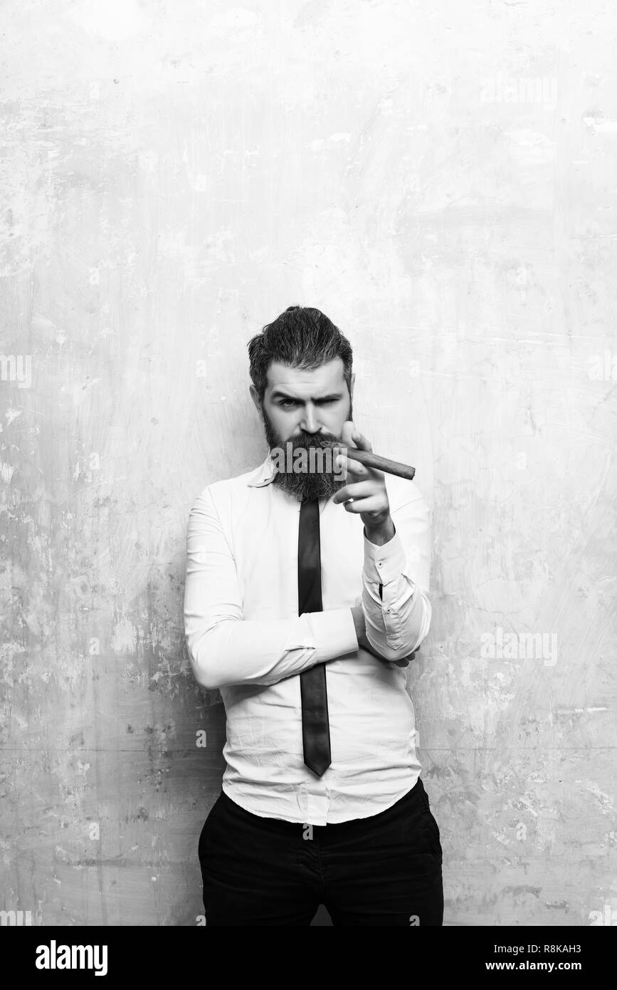 cigar at bearded man on serious face smoking cigar Stock Photo - Alamy