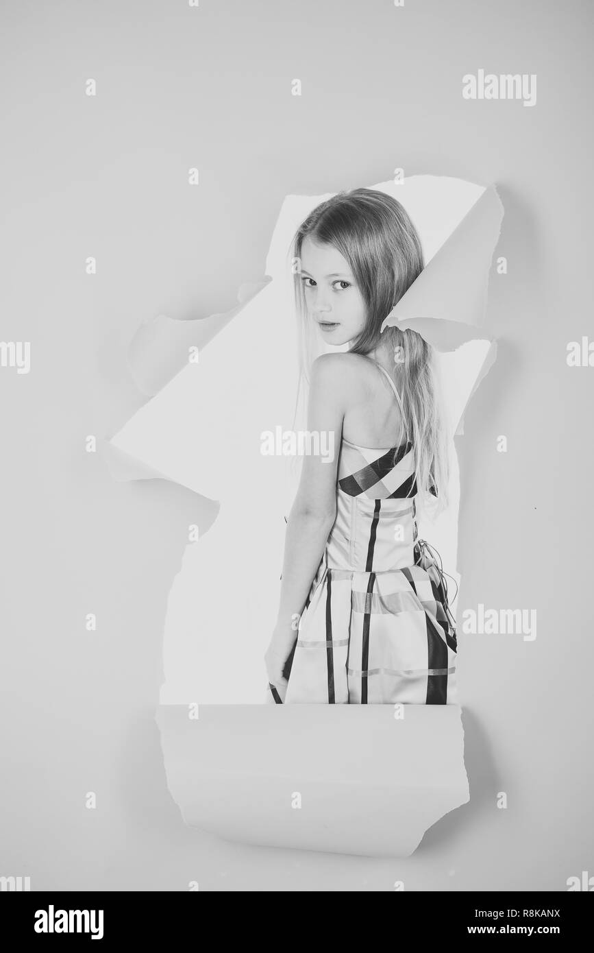 Fashionable little girl with long hair and pin-up dress. Kid's fashion ...