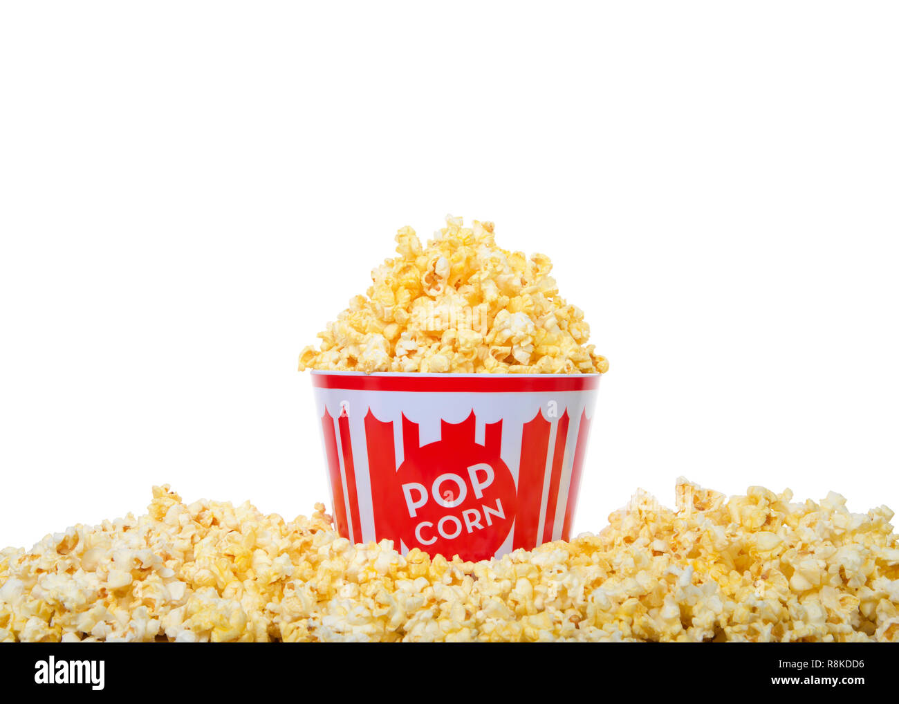 Bucket of pop corn heaped high with popcorn and surrounded by the same ...