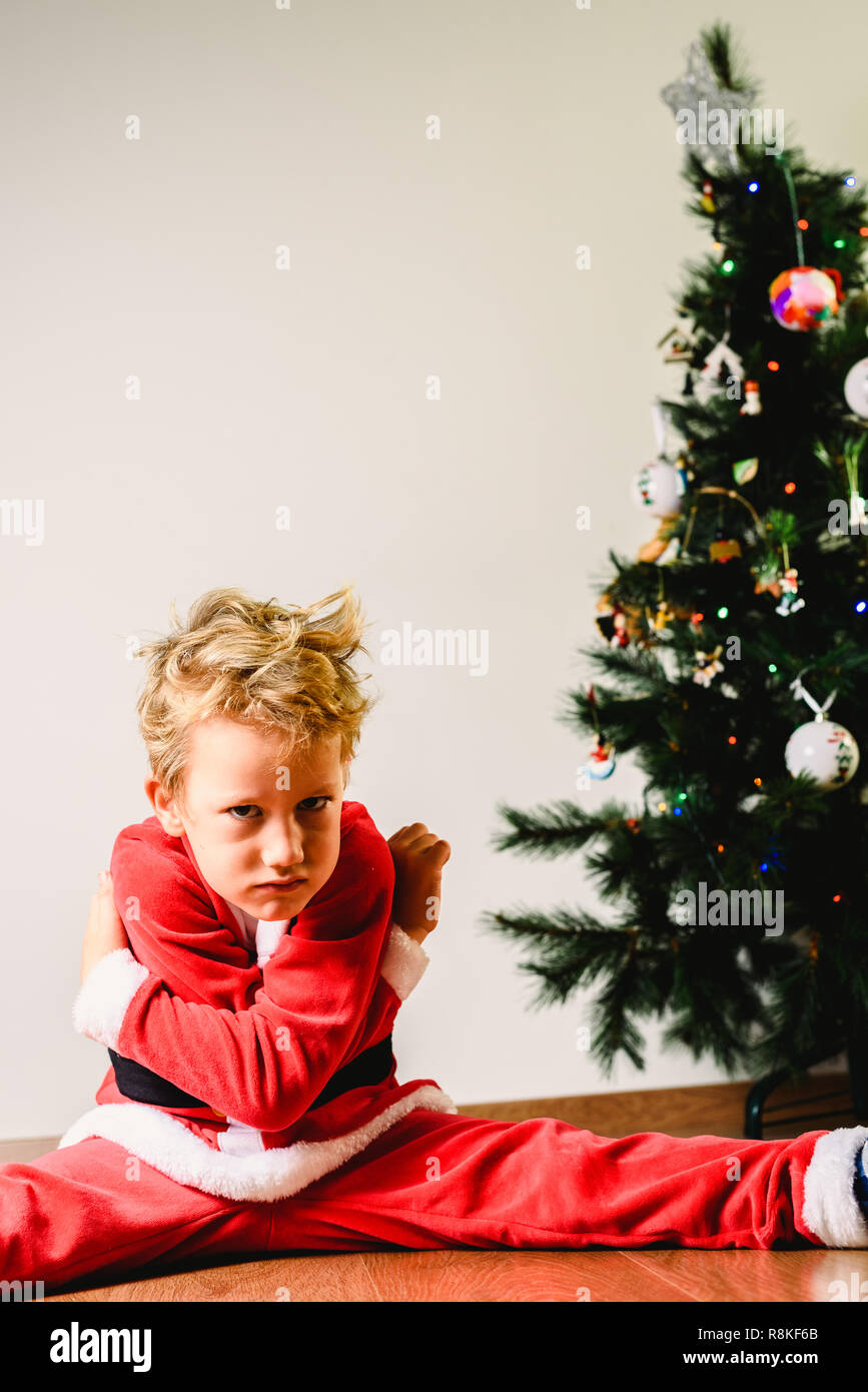 Child with disguise, anxious and sad on Christmas day with an angry ...