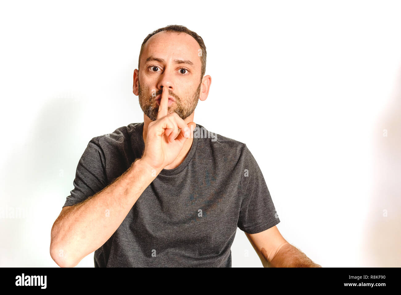 Man in studio asking for silence with a wave of his hand putting a ...