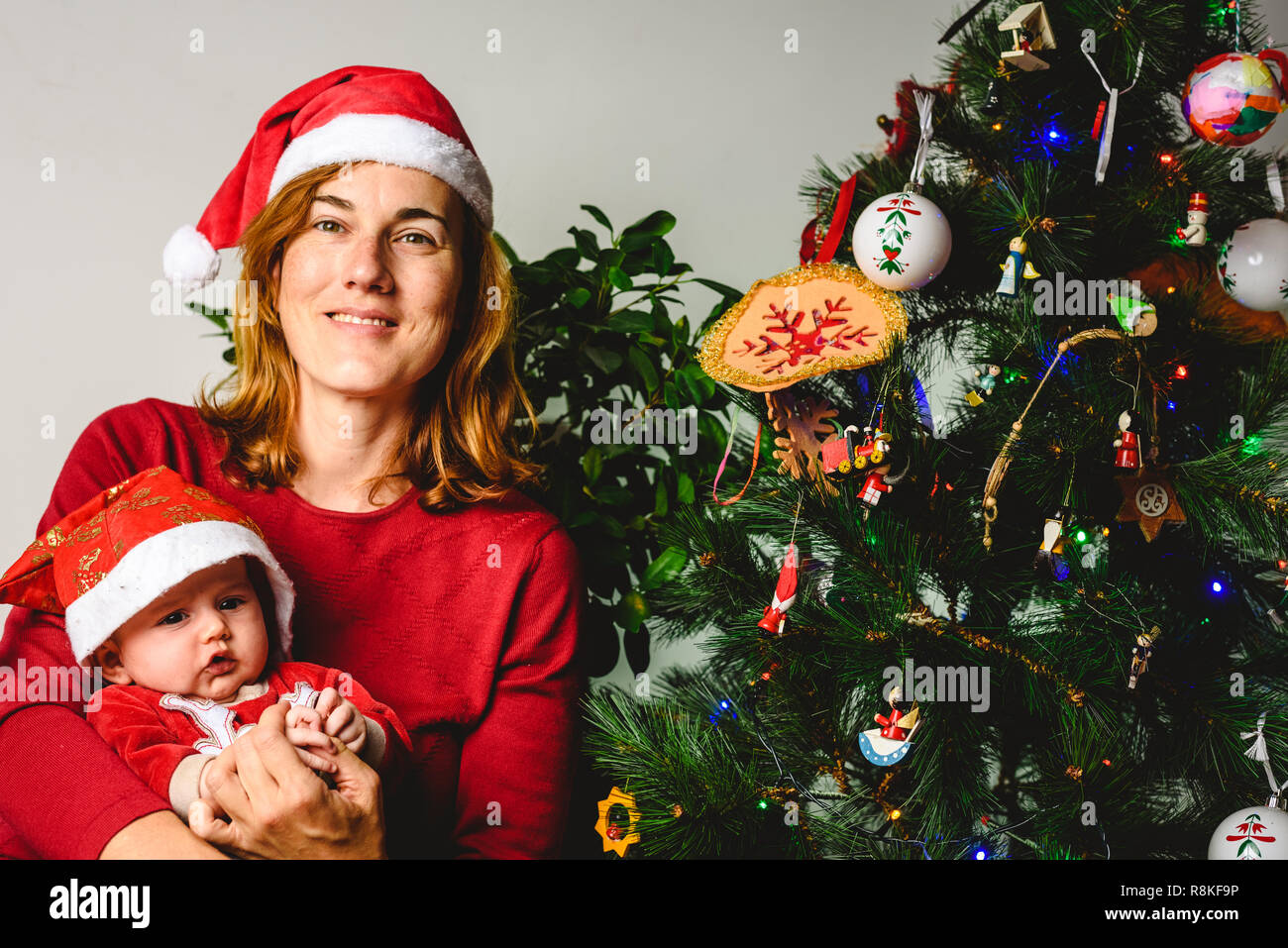 Baby girl dressed as Santa Claus lovingly embraced by her protective ...