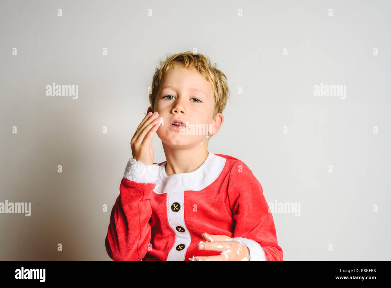 Child in Santa costume playing with shaving cream to have fun at ...