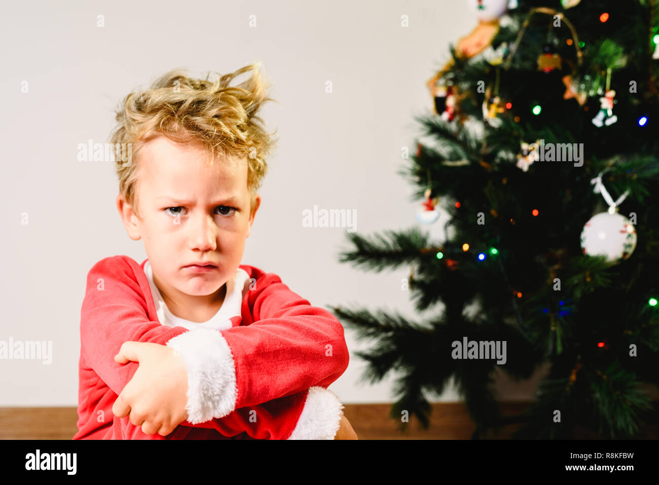 Child with disguise, anxious and sad on Christmas day with an angry ...