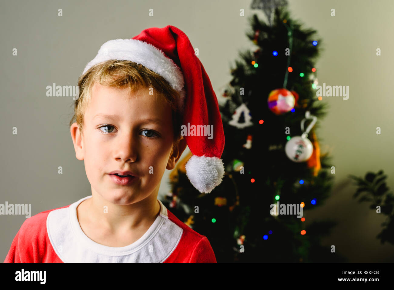 Handsome child waiting for the arrival of Santa Claus dressed as Noel ...