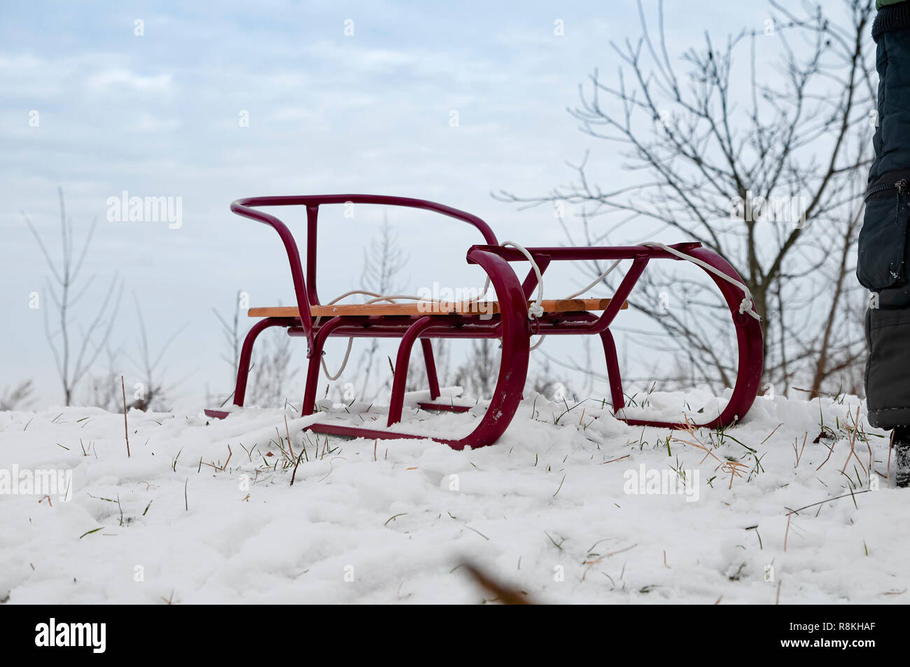 red sledge in the snow Stock Photo - Alamy