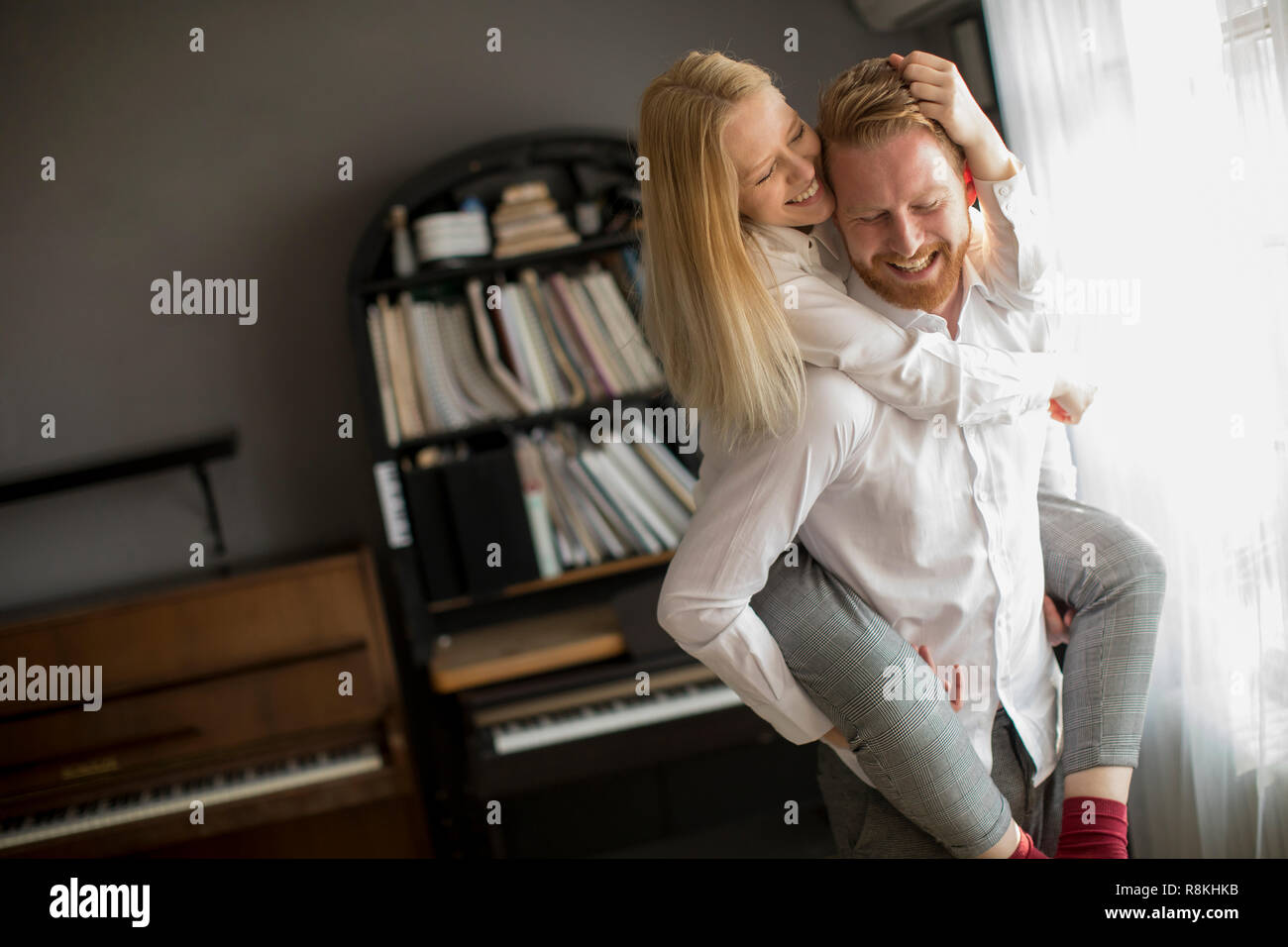 Happy and loving young couple having fun in the room Stock Photo - Alamy