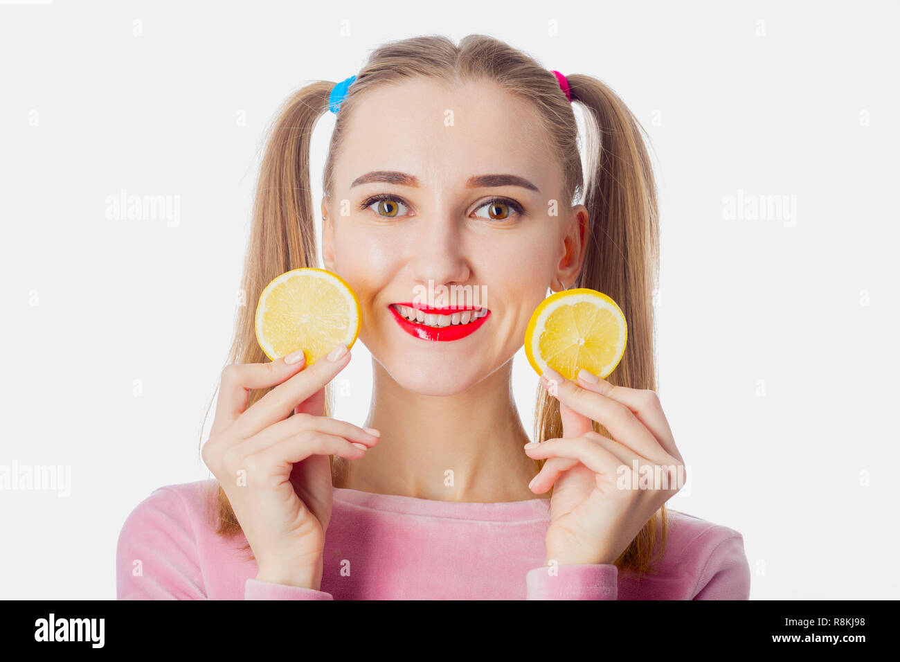 beautiful fun girl with pieces of lemon posing on white background ...