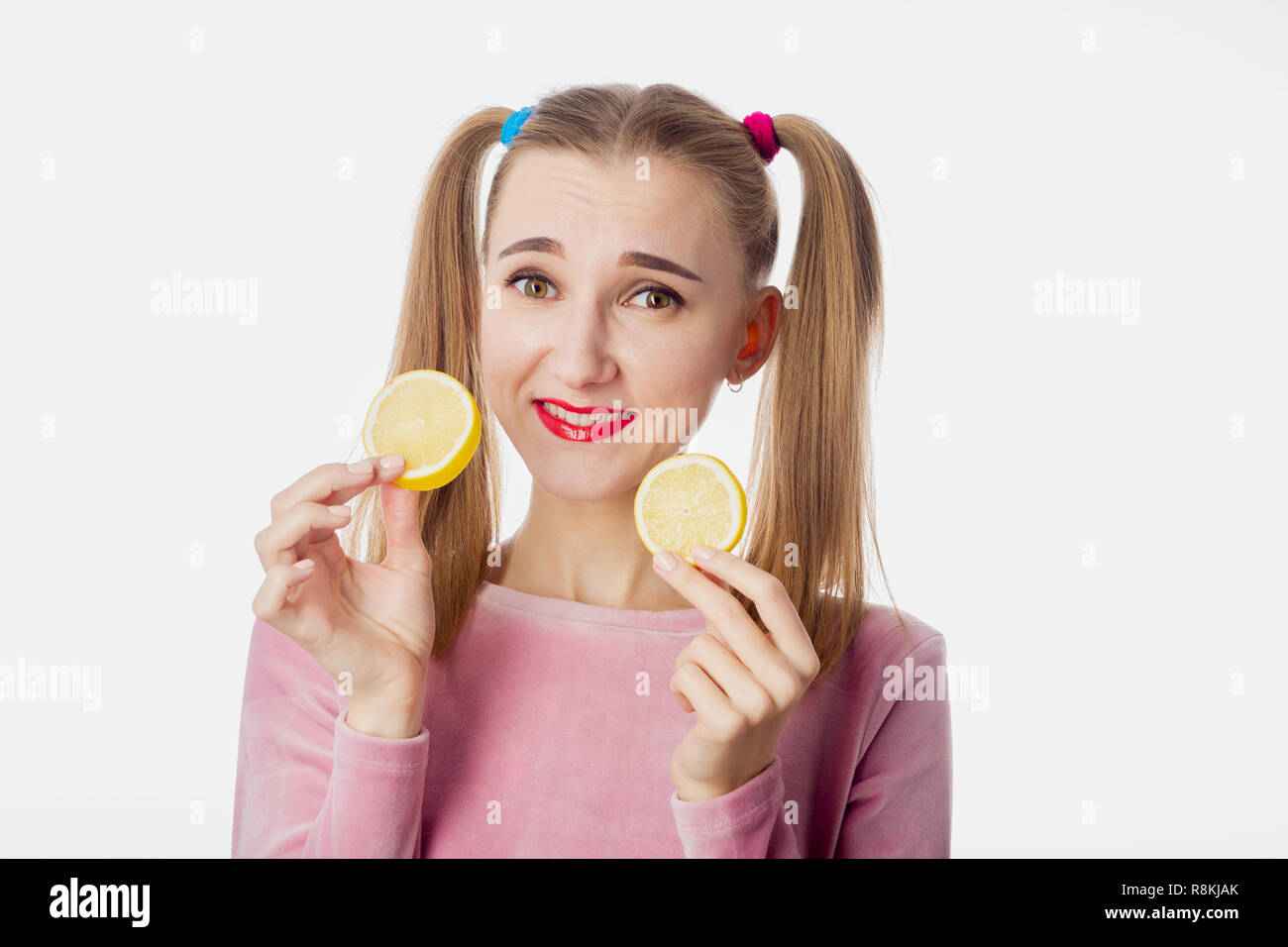 beautiful fun girl with pieces of lemon posing on white background ...