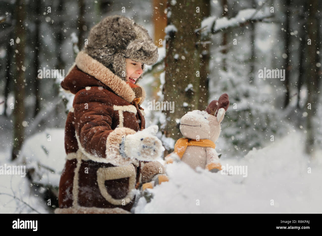 Fun winter child. Winter portrait in a boy outdoors in a brown ...
