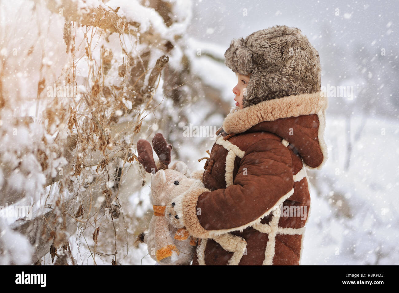 Fun winter child. Winter portrait in a boy outdoors in a brown ...