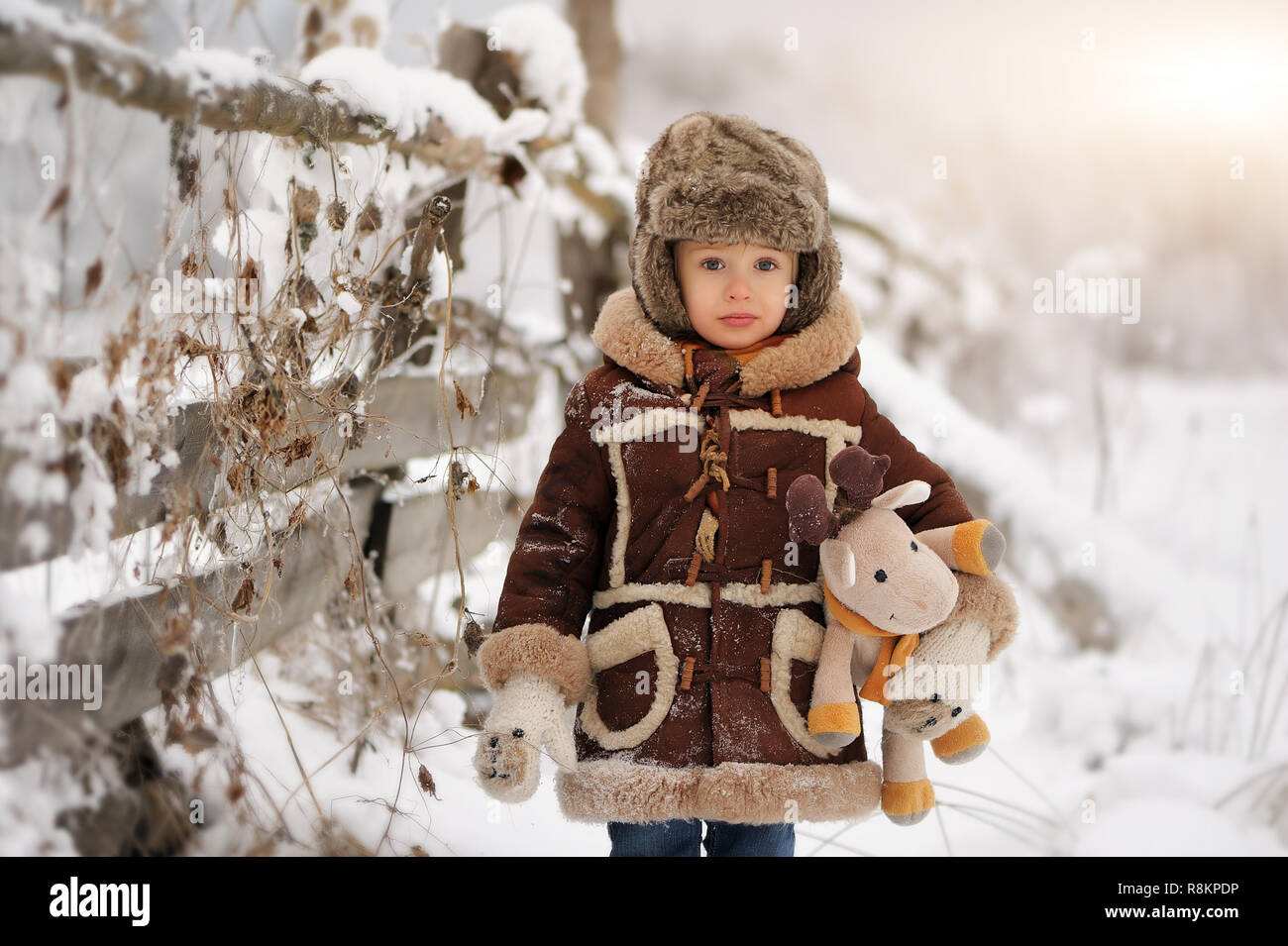 Fun winter child. Winter portrait in a boy outdoors in a brown ...
