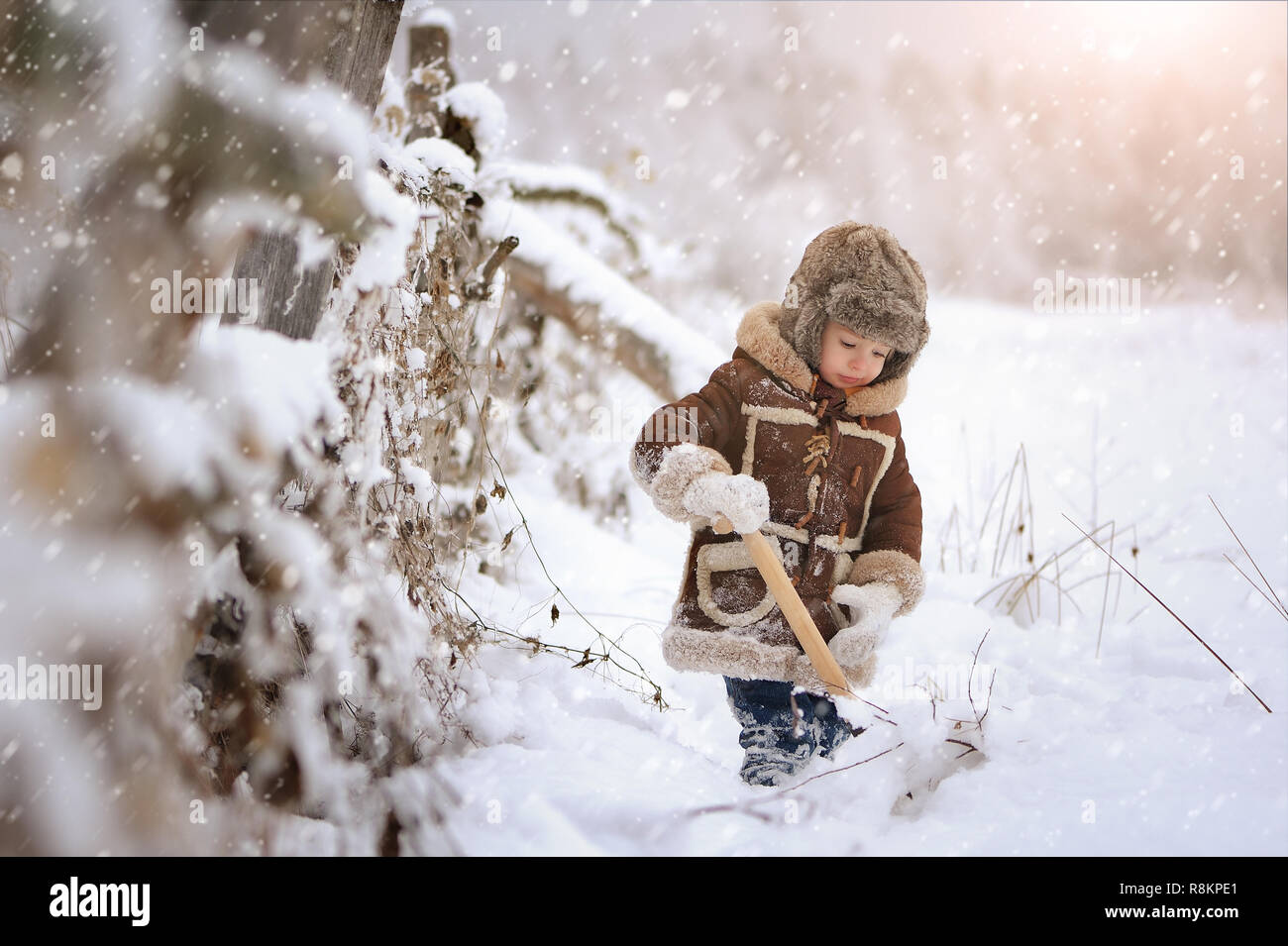 Fun winter child. Winter portrait in a boy outdoors in a brown ...