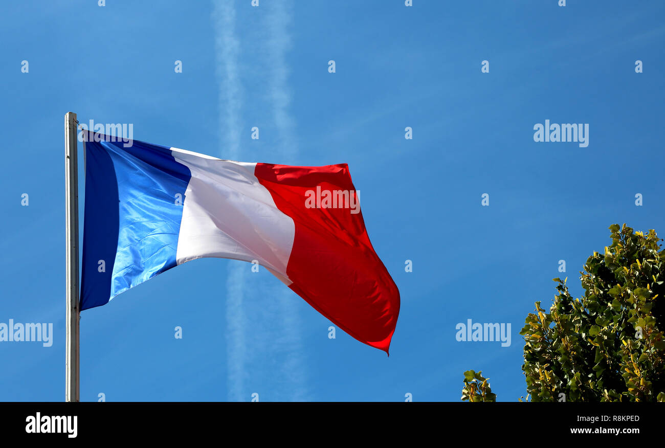 big flag of France waves in the blue sky Stock Photo - Alamy