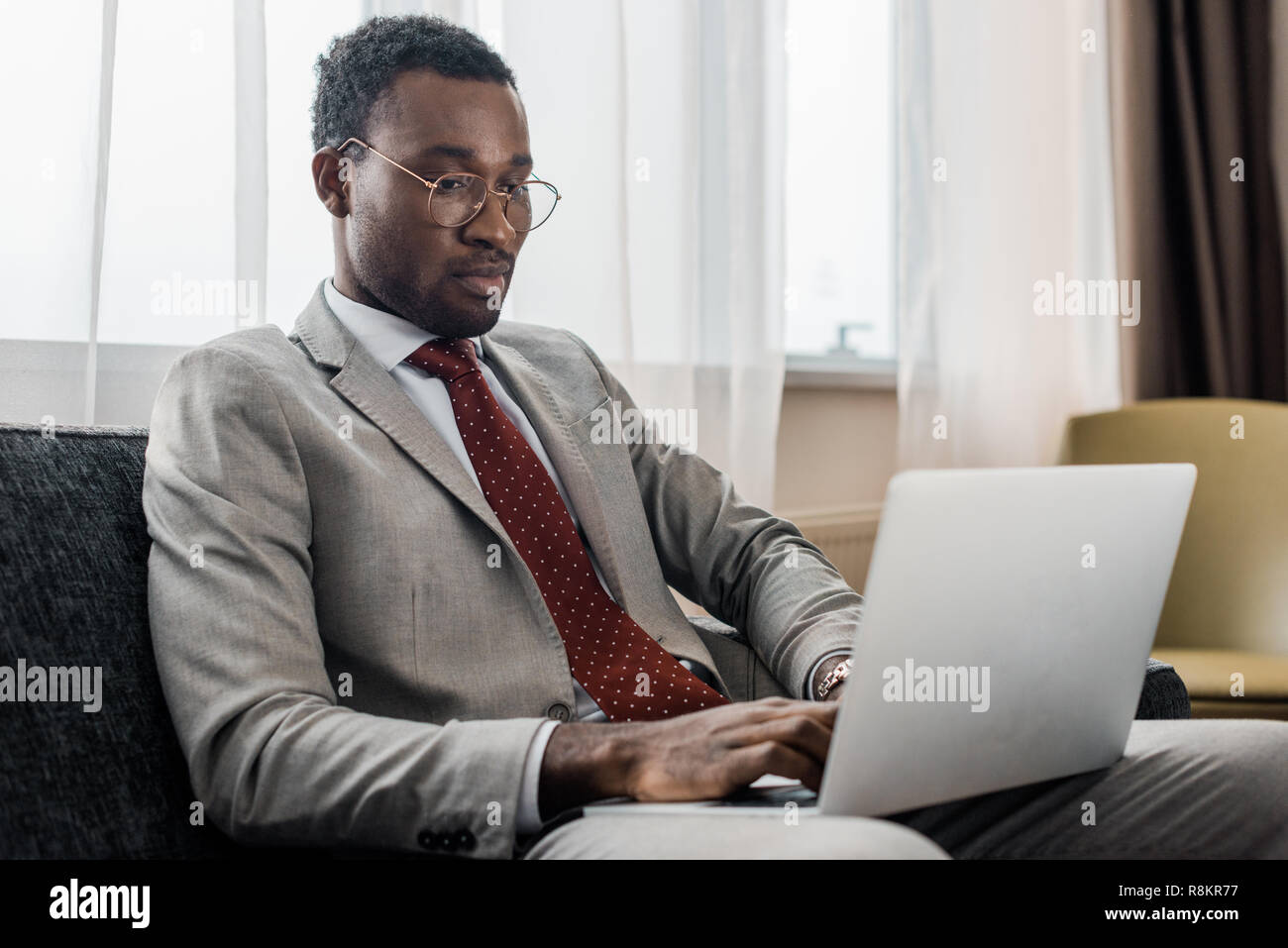 handsome african american businessman using laptop in hotel room Stock ...