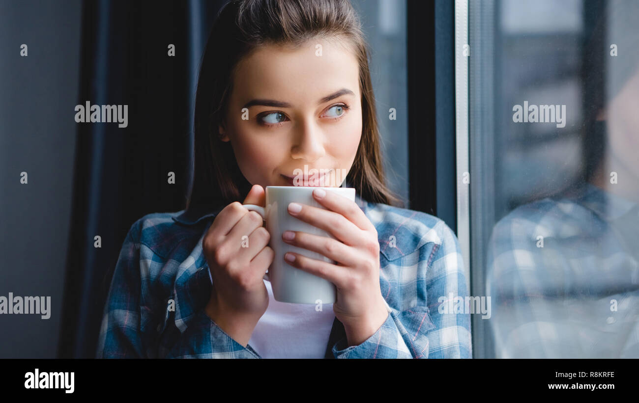 beautiful happy girl drinking tea and looking at window Stock Photo - Alamy