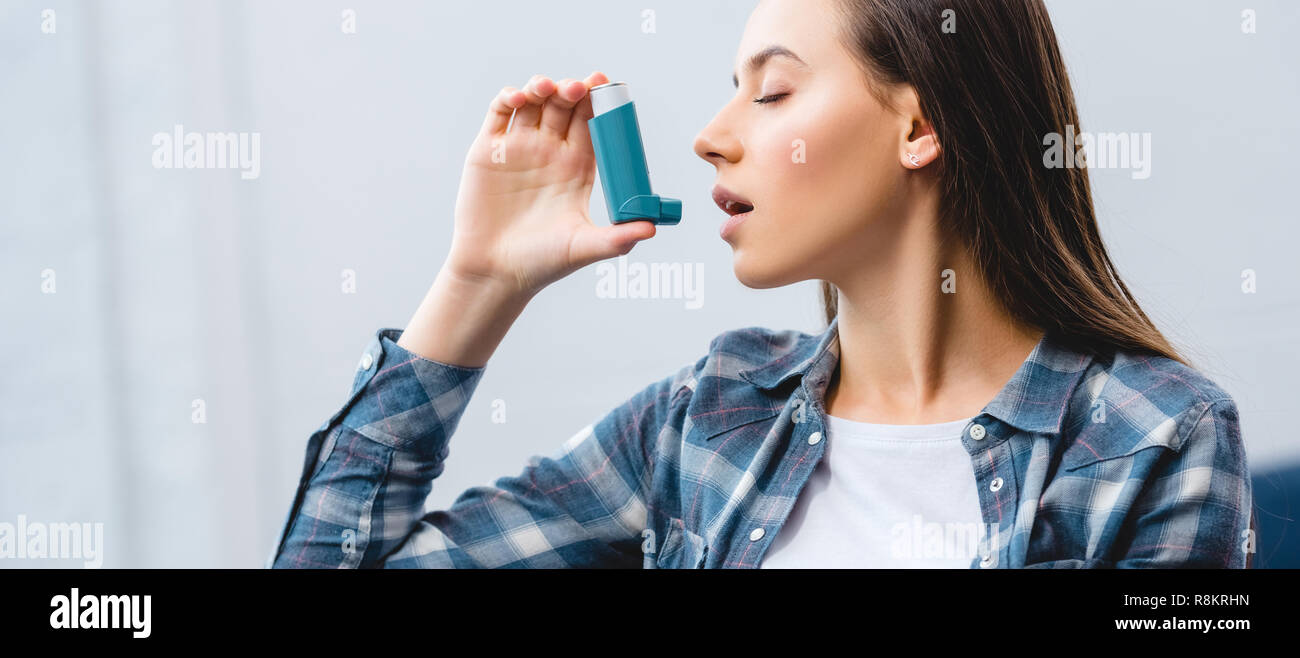 girl using inhaler while suffering from asthma at home Stock Photo - Alamy