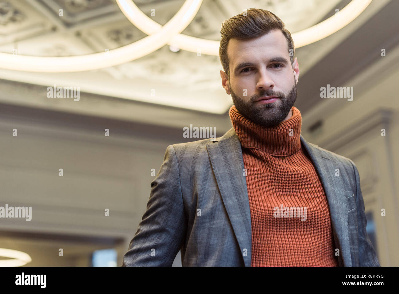 handsome man in formal wear posing and looking at camera Stock Photo ...