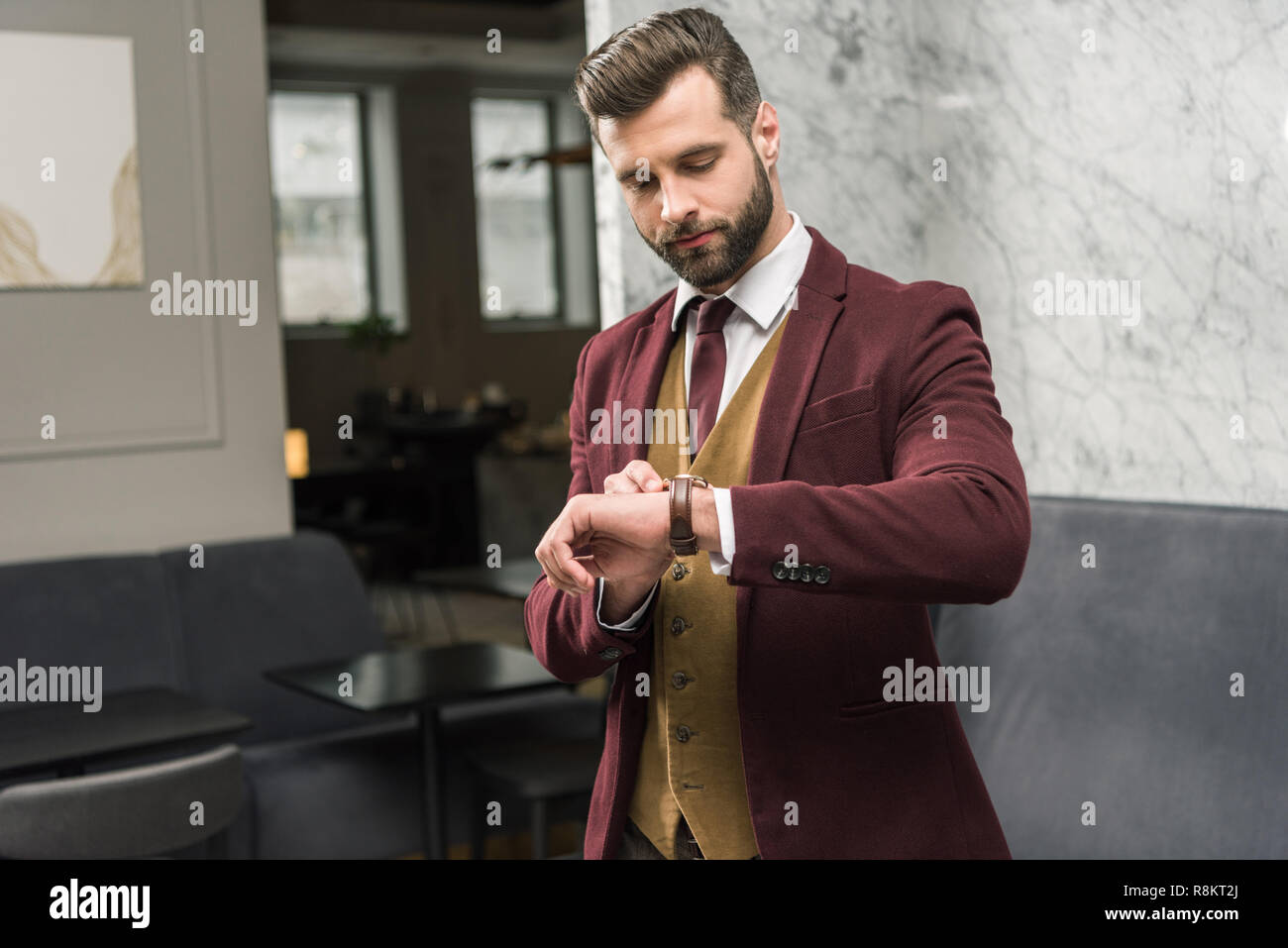 serious businessman in formal wear looking at watch Stock Photo - Alamy