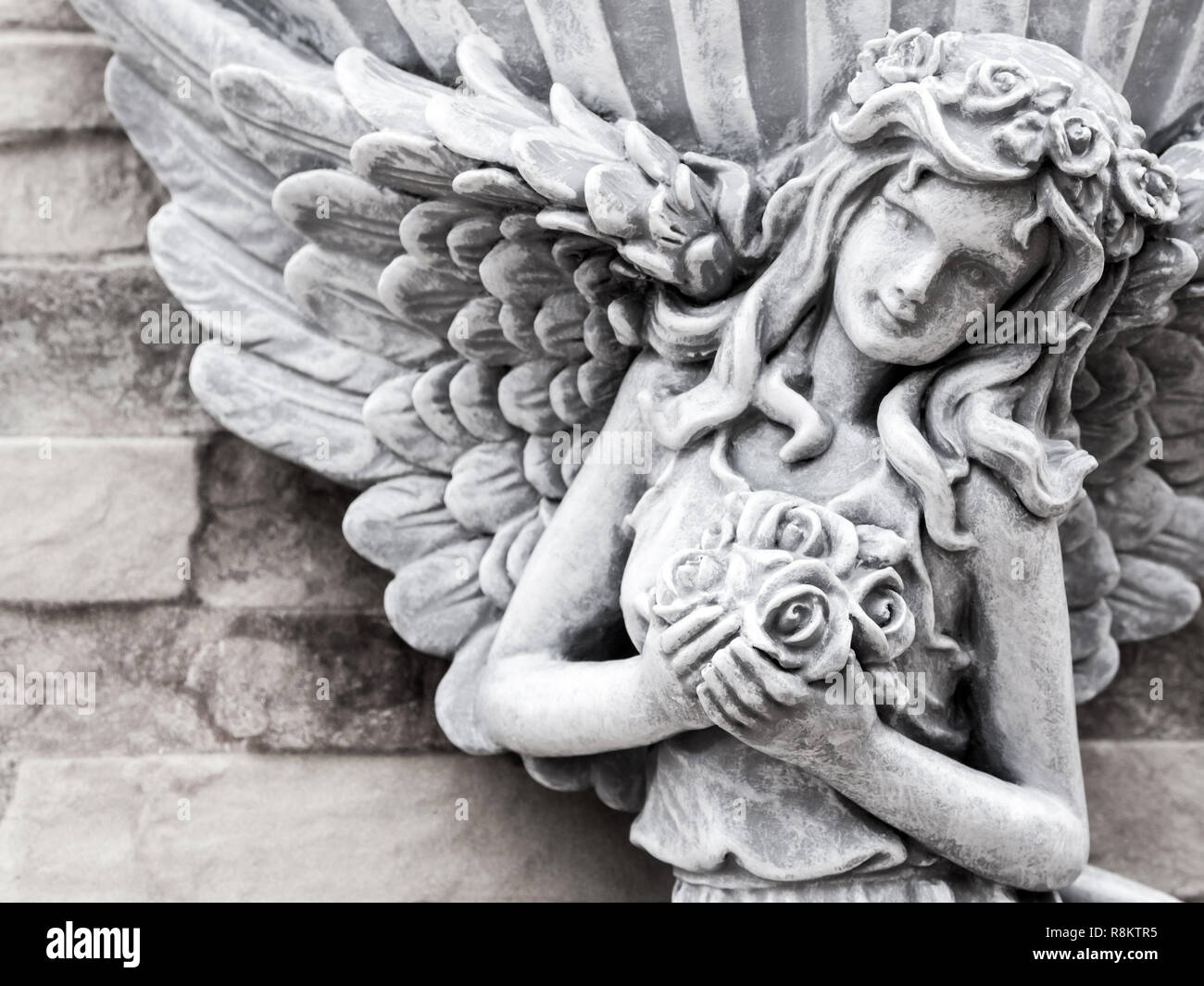 Fairy statue decorated on the stone texture wall Stock Photo - Alamy