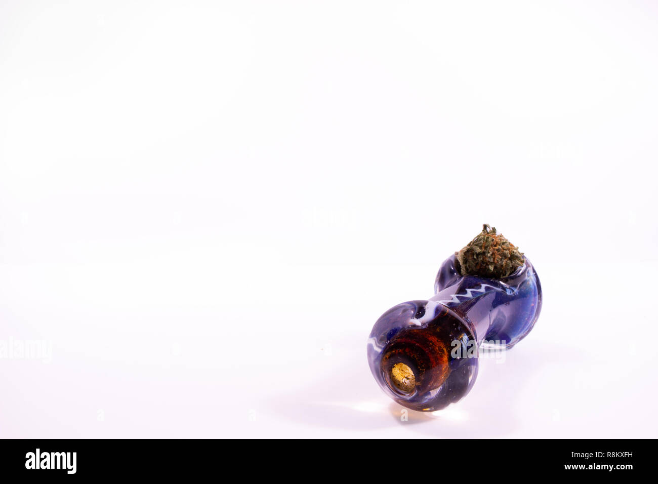 Marijuana glass pipe with weed on a white background with copy space ...