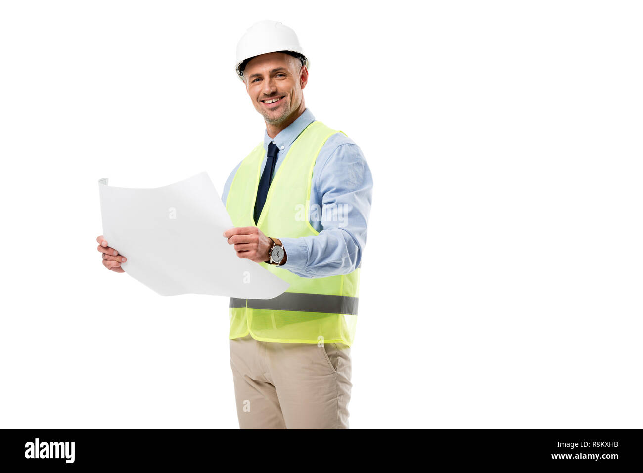 handsome engineer in helmet looking at camera and holding blueprint ...